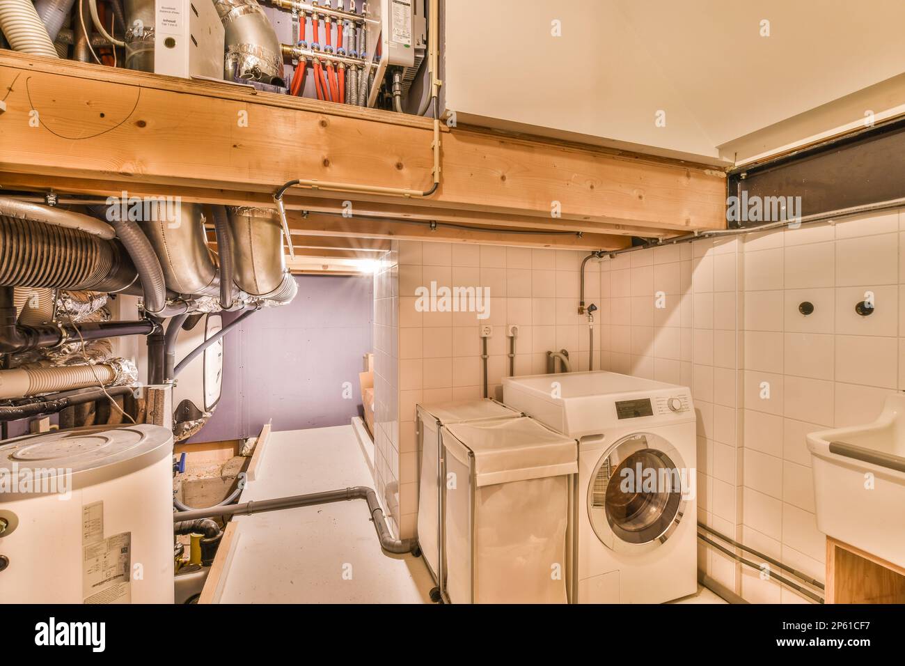 a laundry room with a washer, dryer and washing machine on the wall in ...