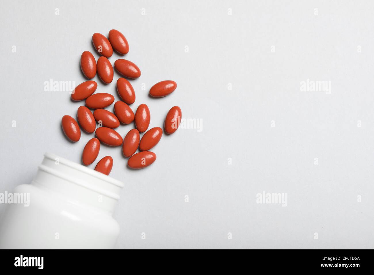 Pills, bottle and space for text on light grey background, flat lay ...