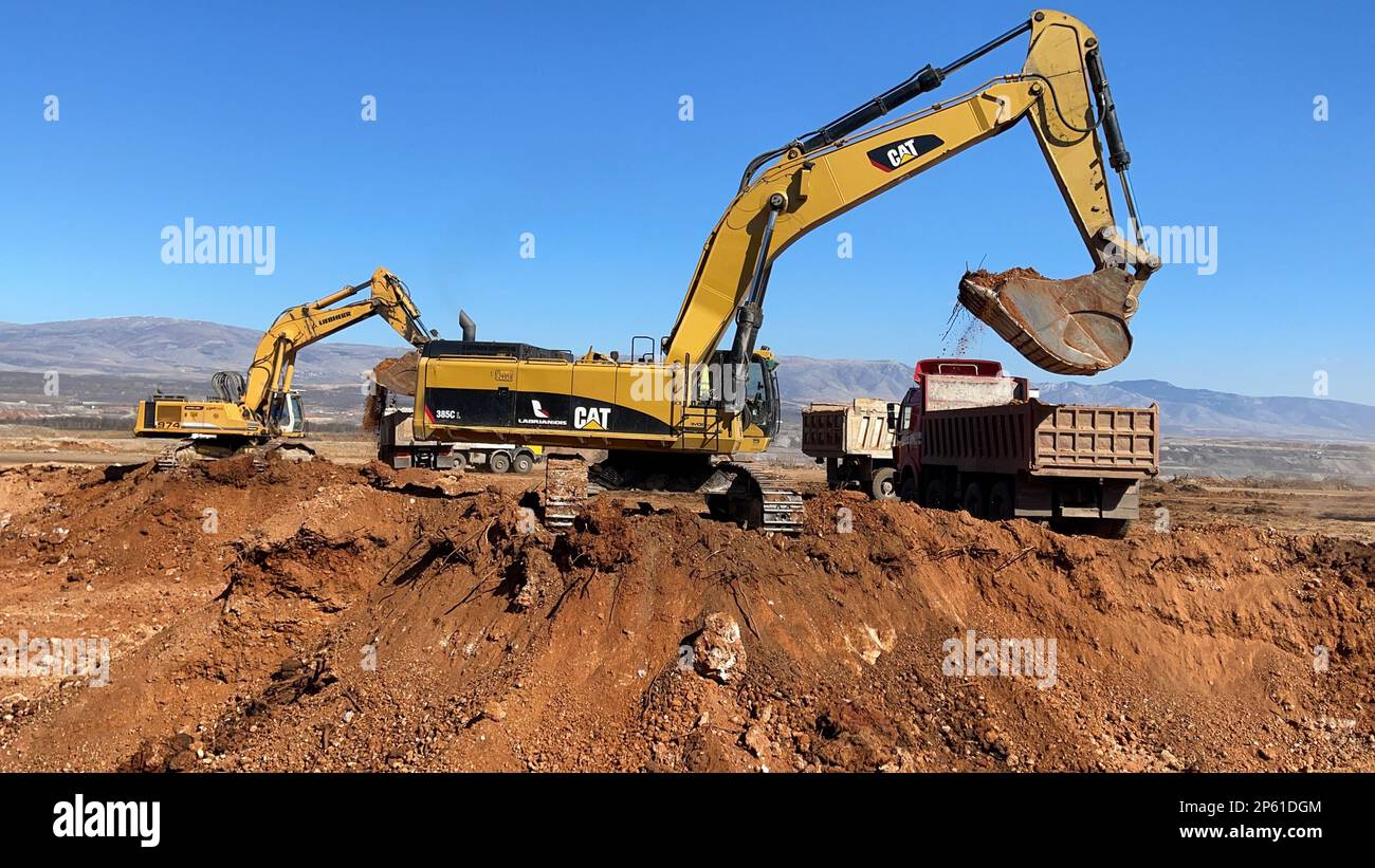 Excavators Working On Huge Mining Site, Loading The Trucks, Trucks ...