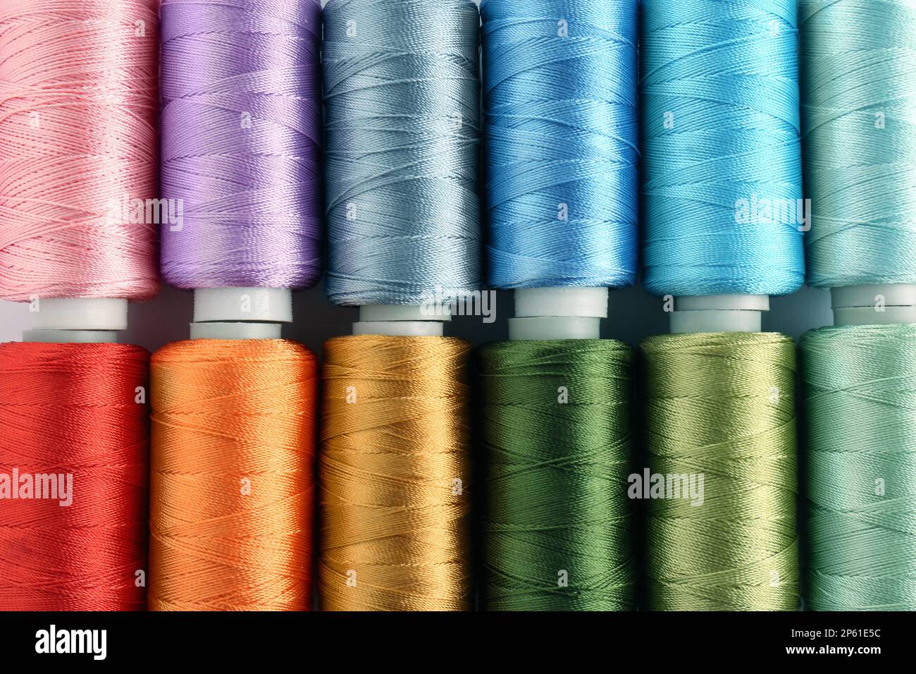 Set of colorful sewing threads as background, top view Stock Photo - Alamy