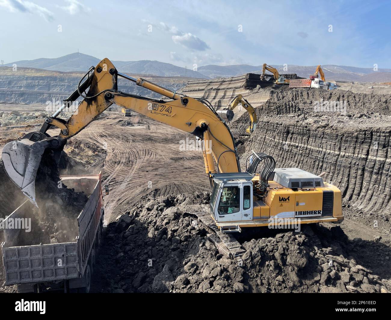 Excavators Working On Huge Mining Site, Loading The Trucks, Trucks ...