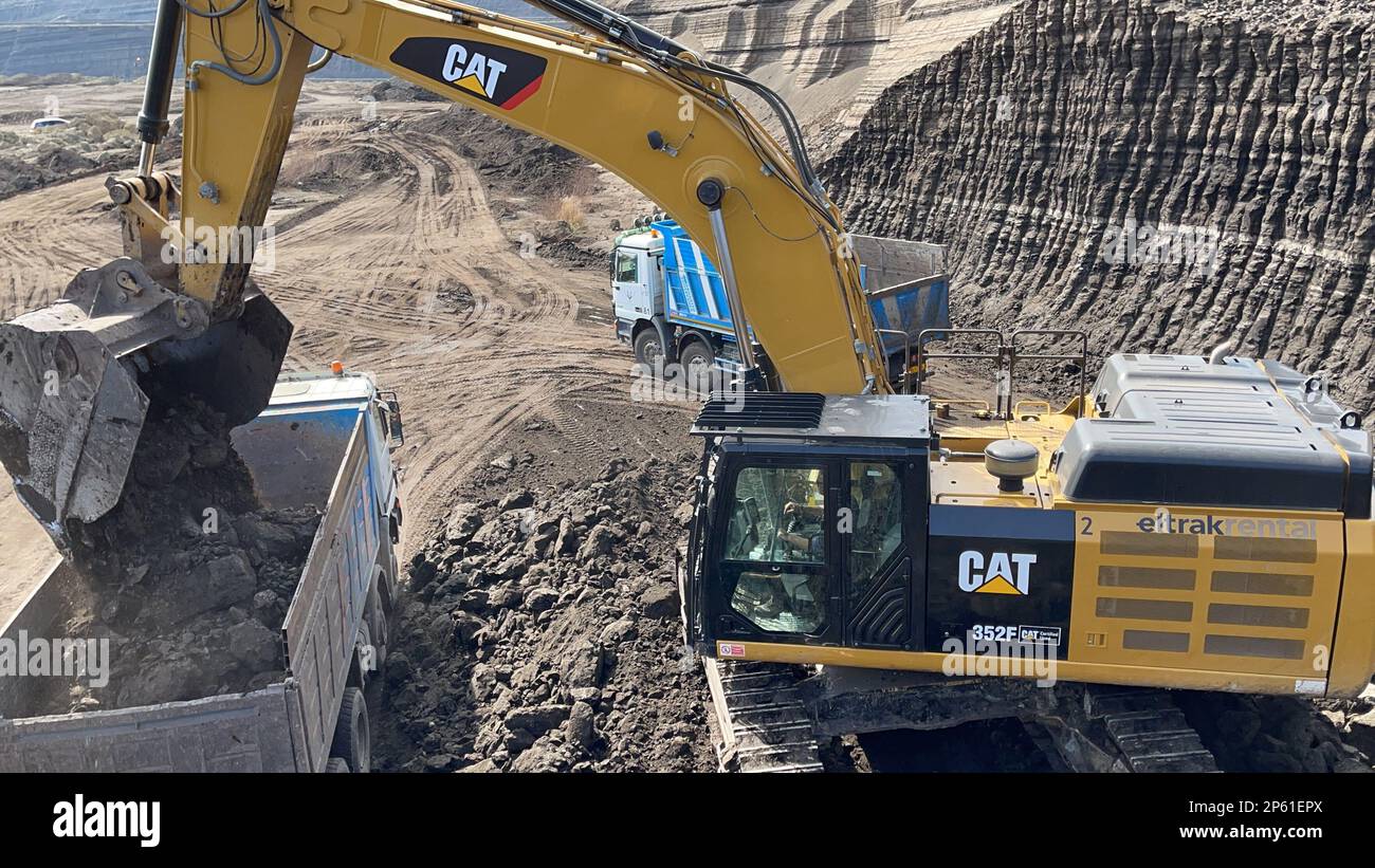 Excavator Working On Huge Mining Site, Loading The Trucks, Trucks ...