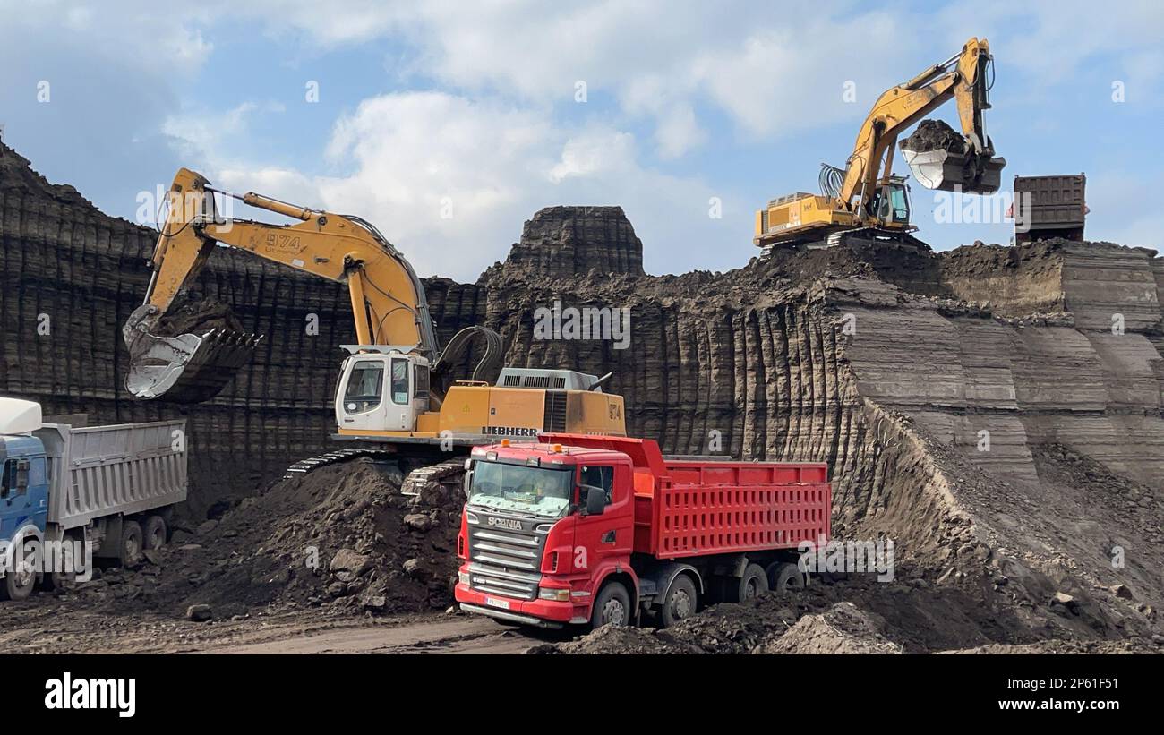 Excavators Working On Huge Mining Site, Loading The Trucks, Trucks ...