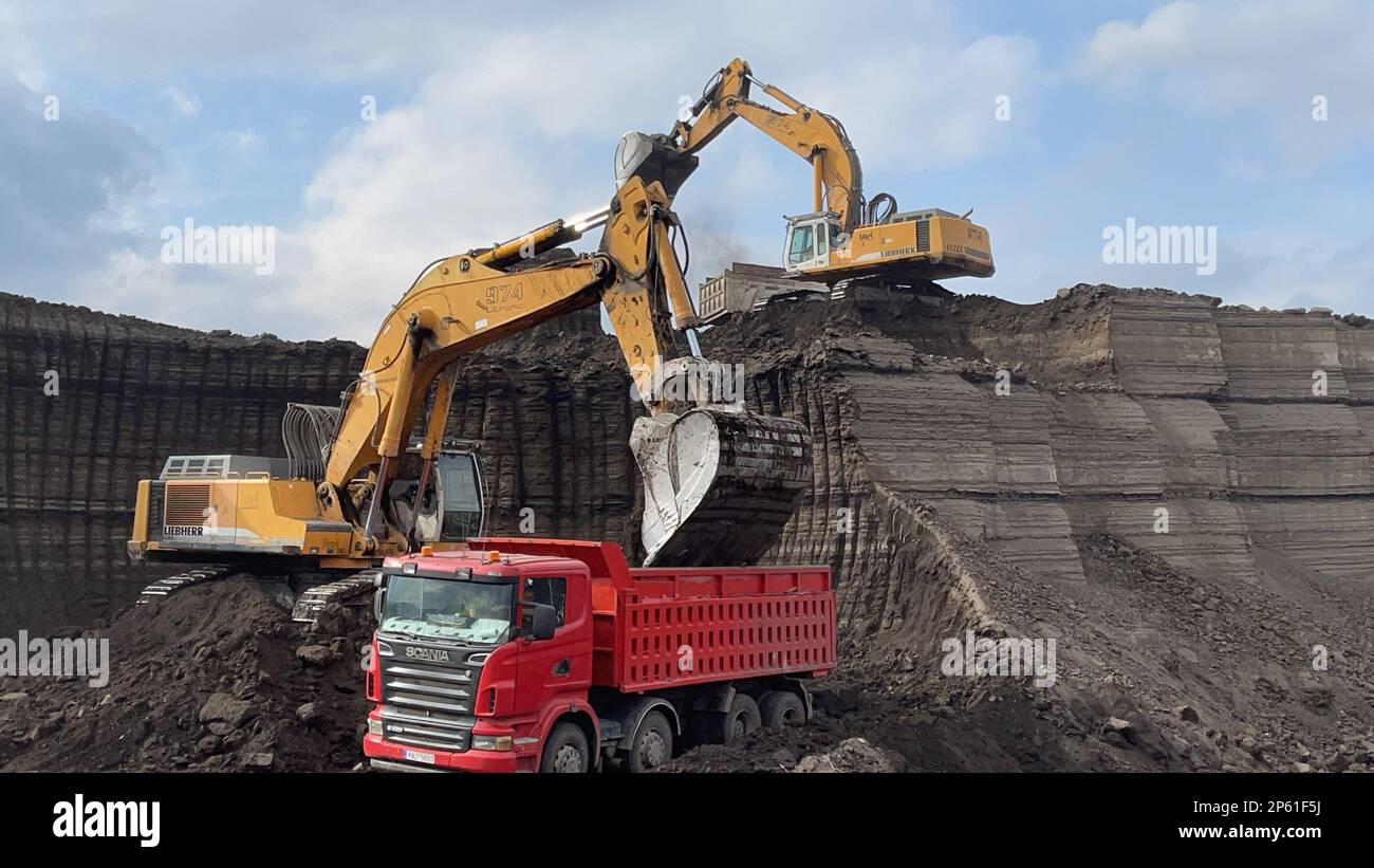 Excavators Working On Huge Mining Site, Loading The Trucks, Trucks ...