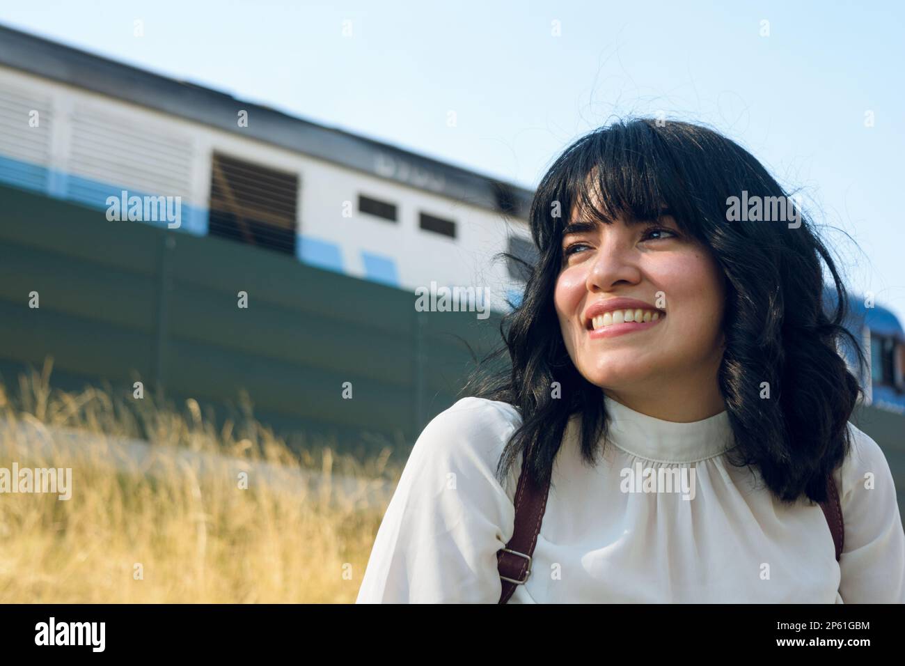 young venezuelan woman with short hair and casual clothes, in a park ...