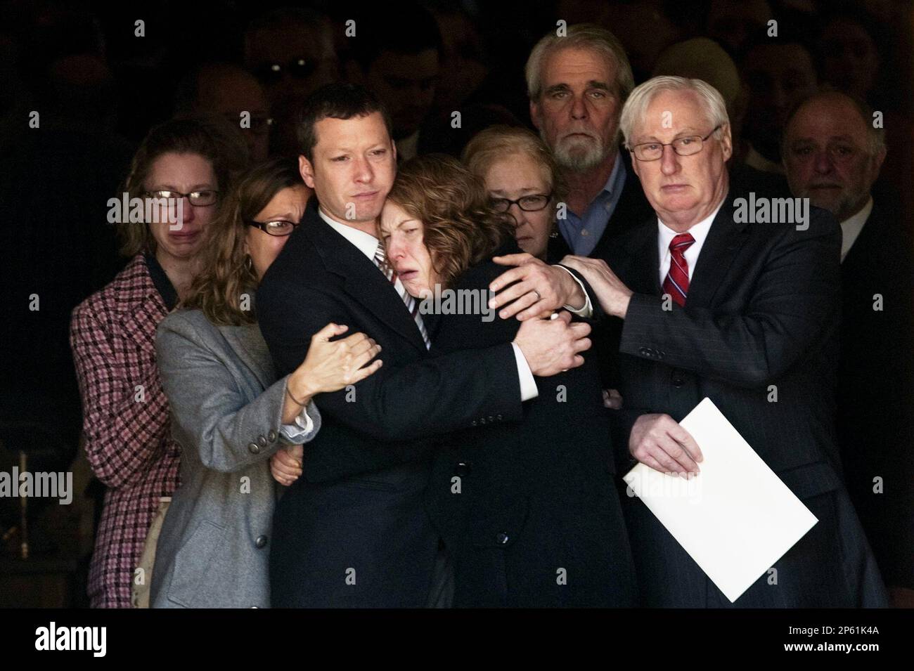 Jason Derkosh holds his wife, Elizabeth, at the funeral of their 2-year ...