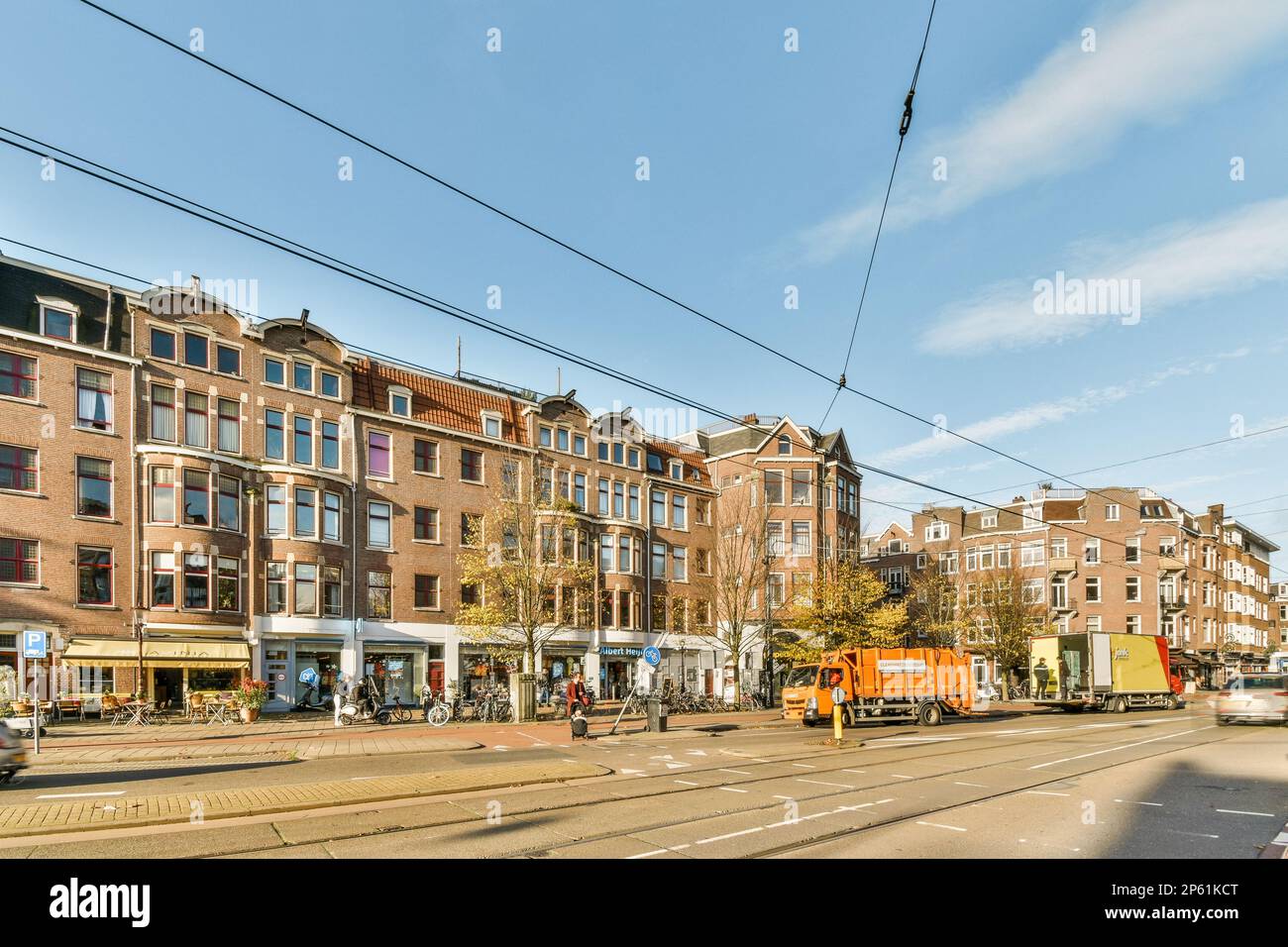 a city street with cars and buildings on both sides, in the middle of ...