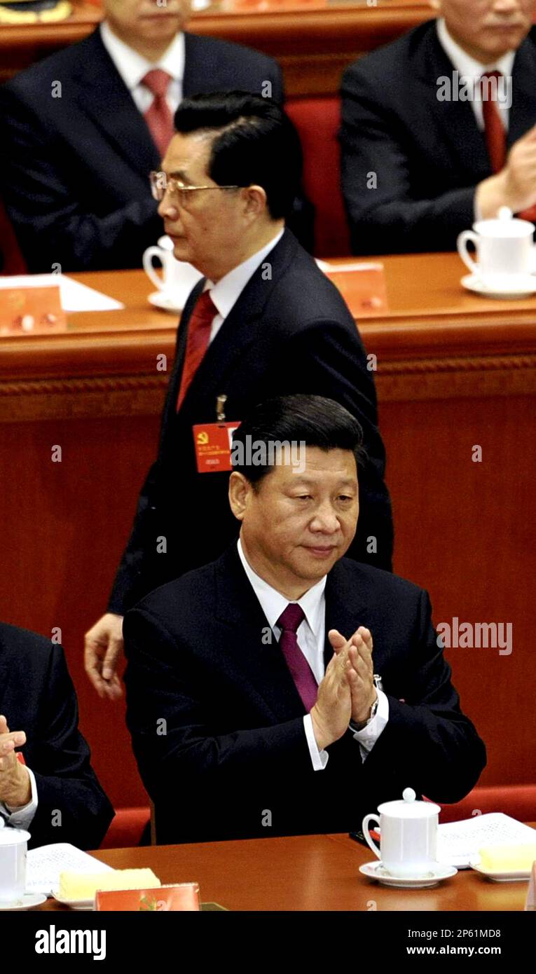 China's Vice President Xi JingPing (bottom) claps his hands as ...