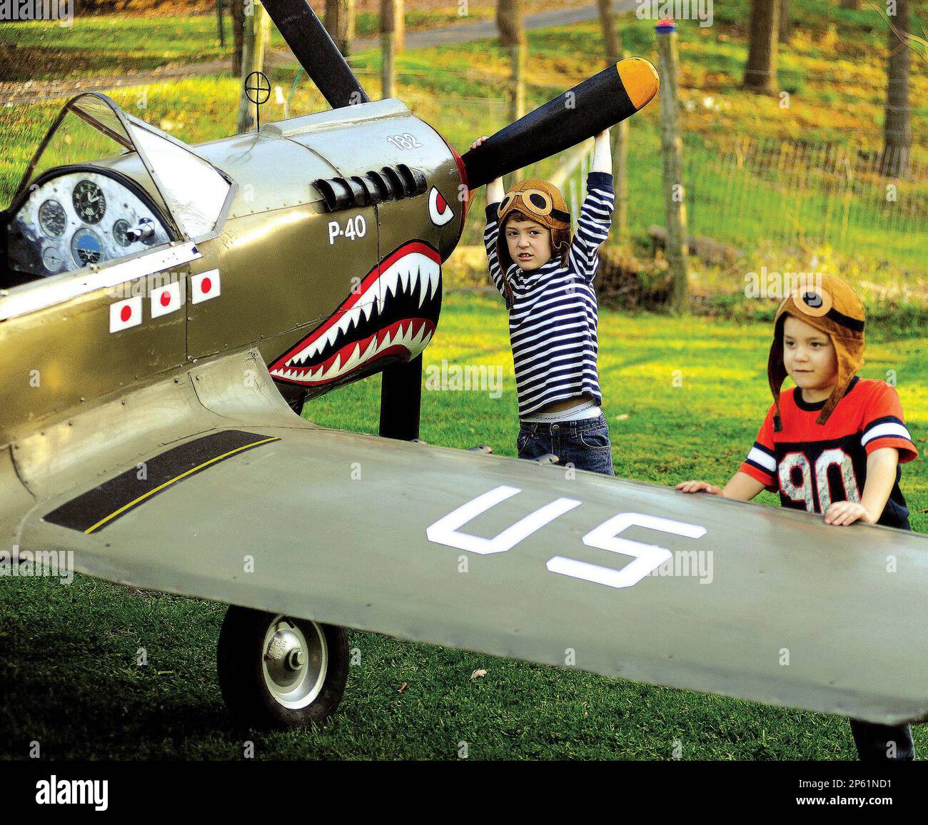 Nathaniel and Andrew Lakatos stand by a replica of a World WWII P-40 ...