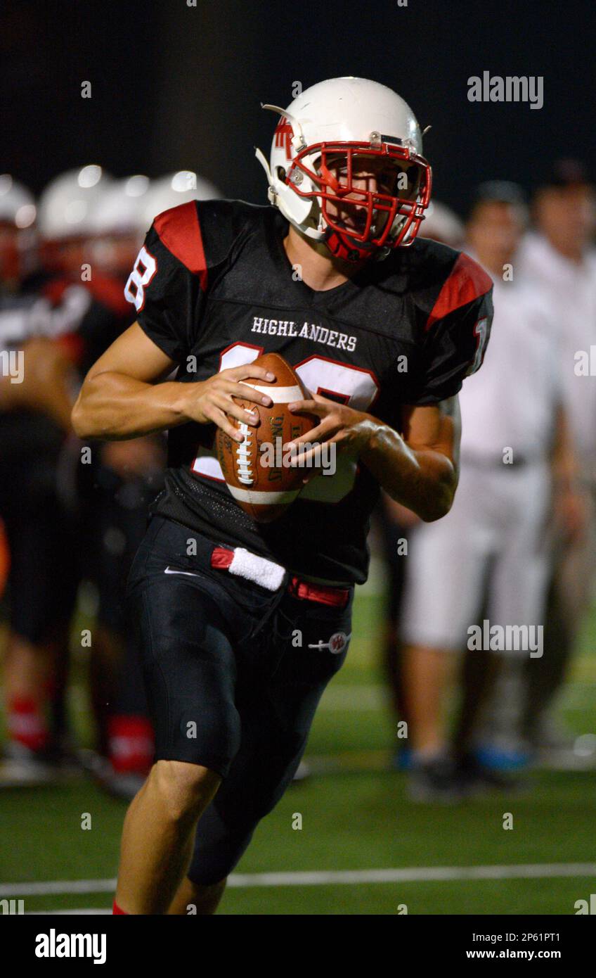 Lake Highland quarterback Evan Jager rolls out during warmups before a ...