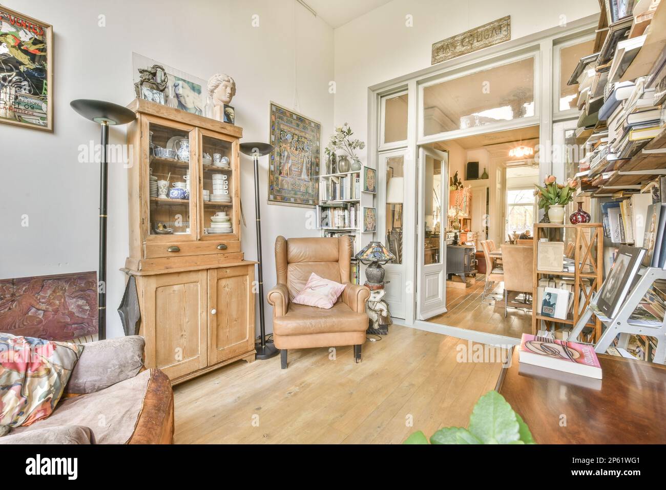 a living room with lots of stuff on the walls and furniture in the ...