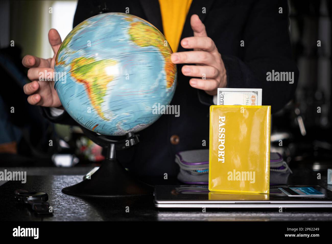 a man turns a globe to choose a country to travel to. the tourist ...