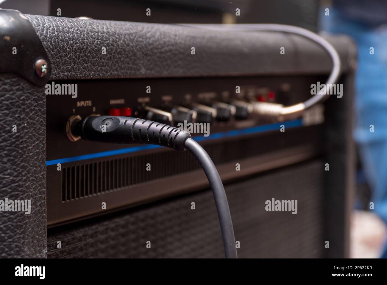 Plug jack with cable plugged into a black guitar combo amplifier Stock ...