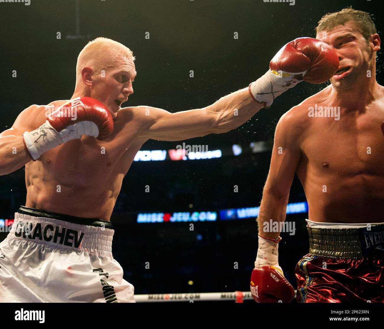 Lucian Bute, right, from Montreal, takes a left to the head from Denis ...