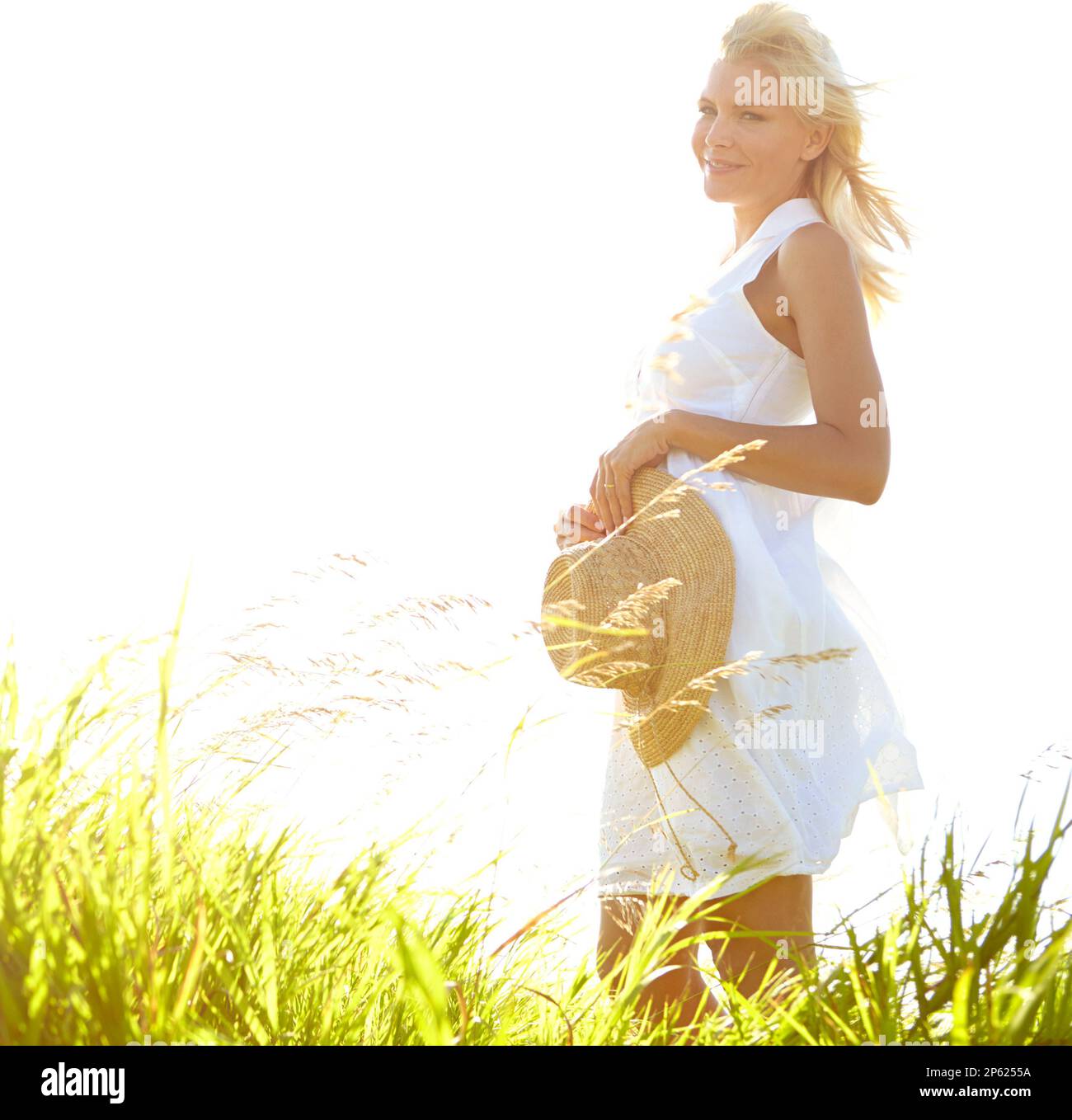 I find peace in nature. Side view of a gorgeous young woman standing in ...
