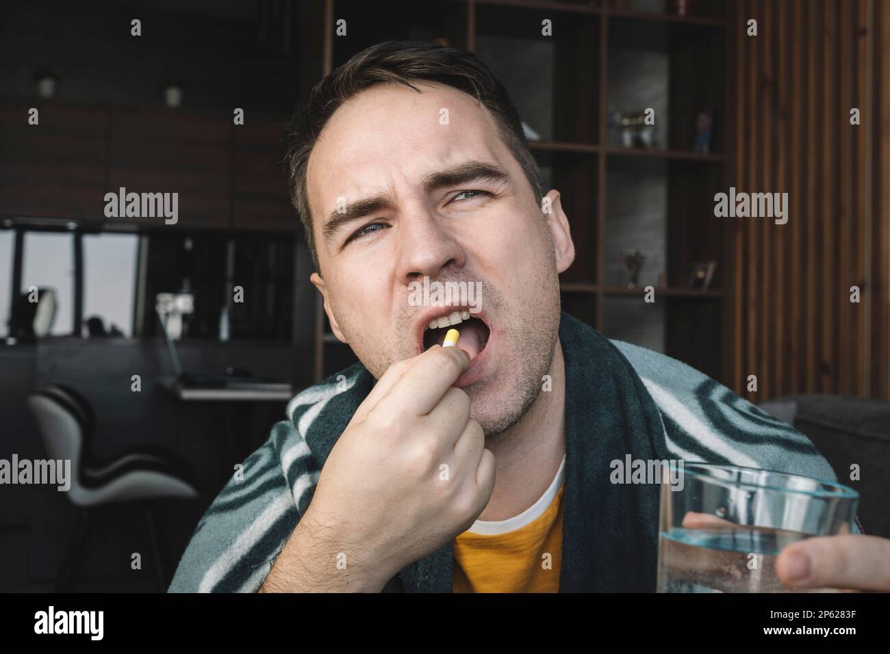 young man take medicine,open mouth and bring medicine to mouth. self ...