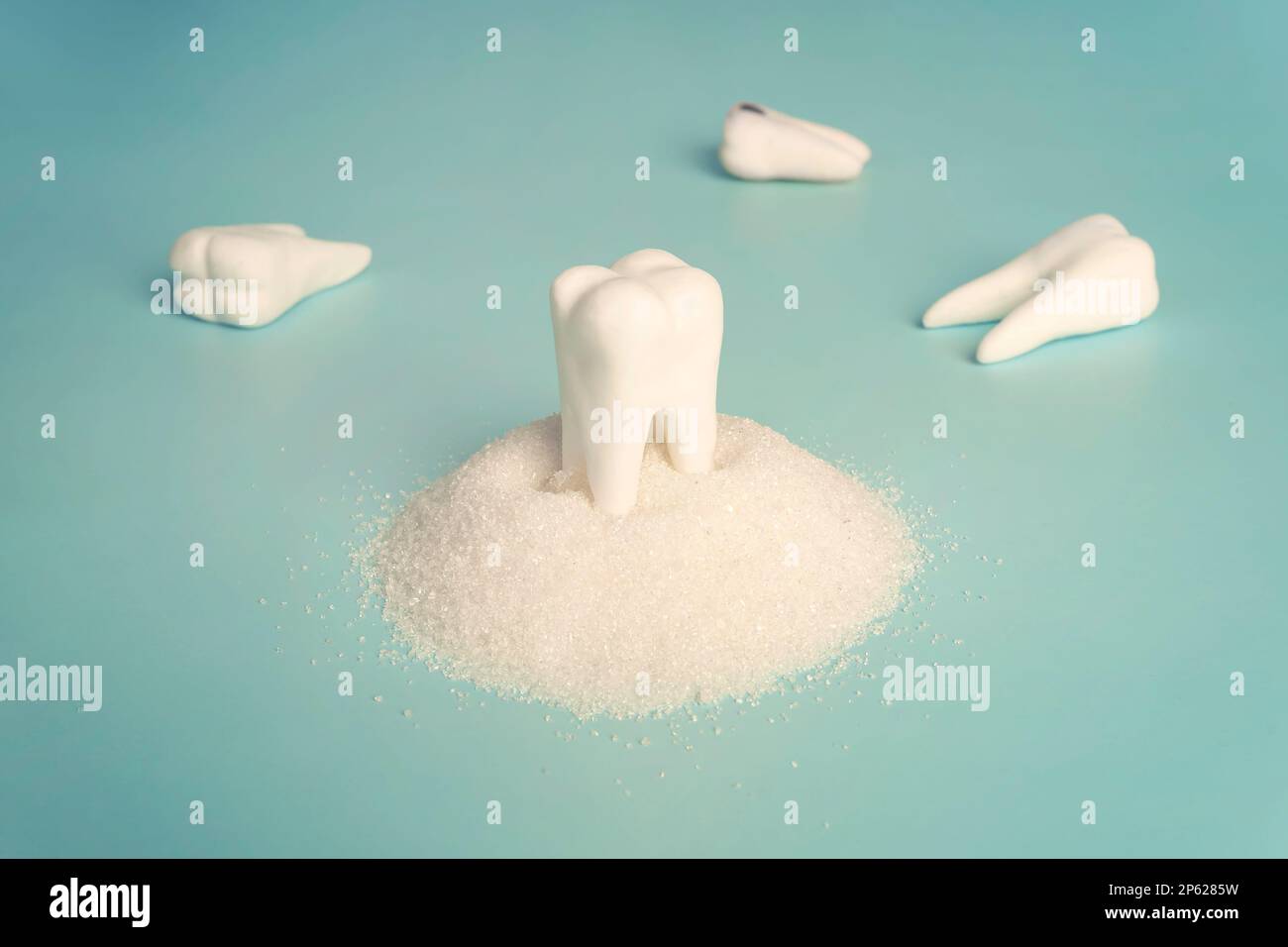 Tooth with sugar on blue background. Harm sugar and sweet for teeth ...