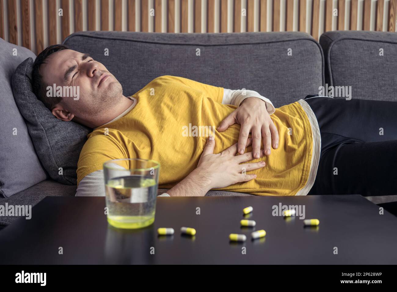 Man stomach ache table hi-res stock photography and images - Alamy