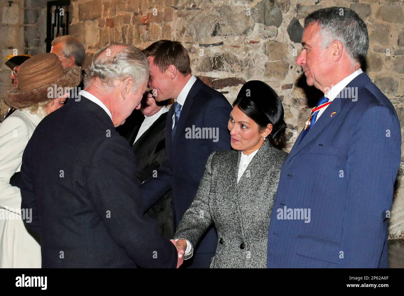 King Charles III is greeted by Priti Patel, during a visit to ...