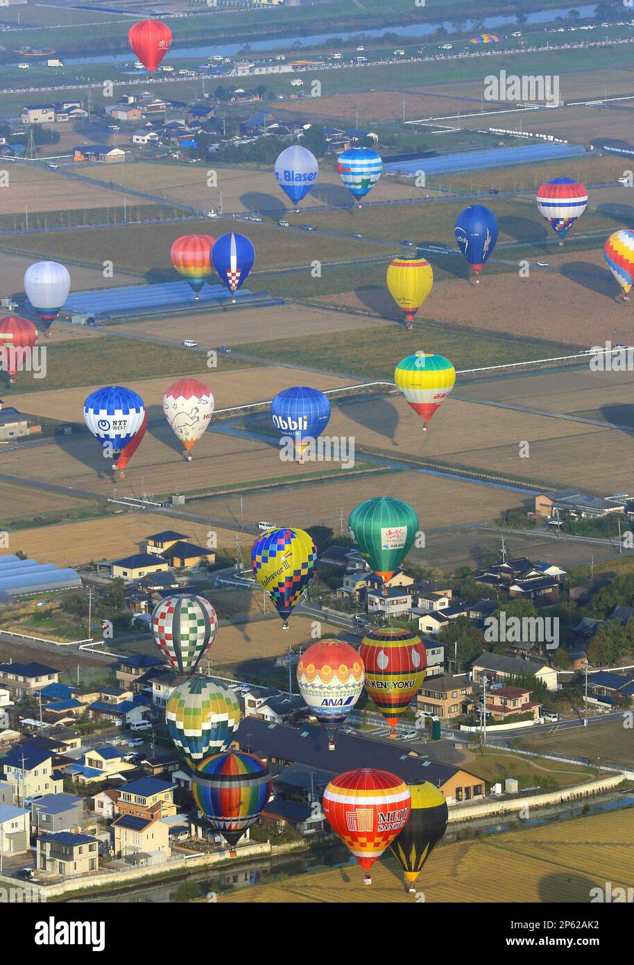 Colorful hot air balloons are floating up in the morning sky at the Saga International Balloon ...