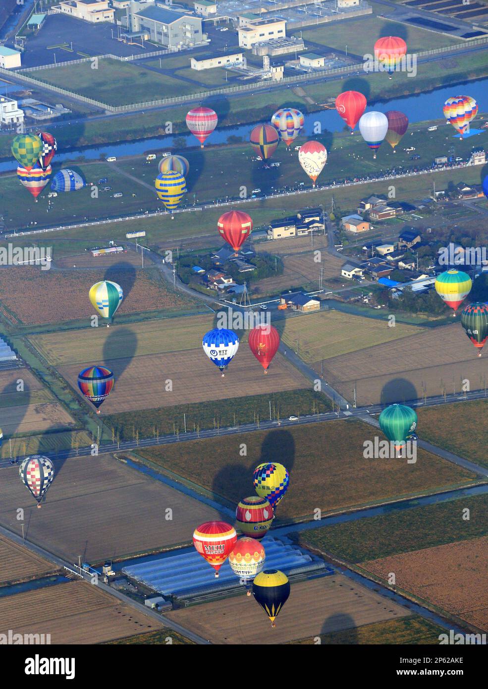 Colorful hot air balloons are floating up in the morning sky at the Saga International Balloon ...