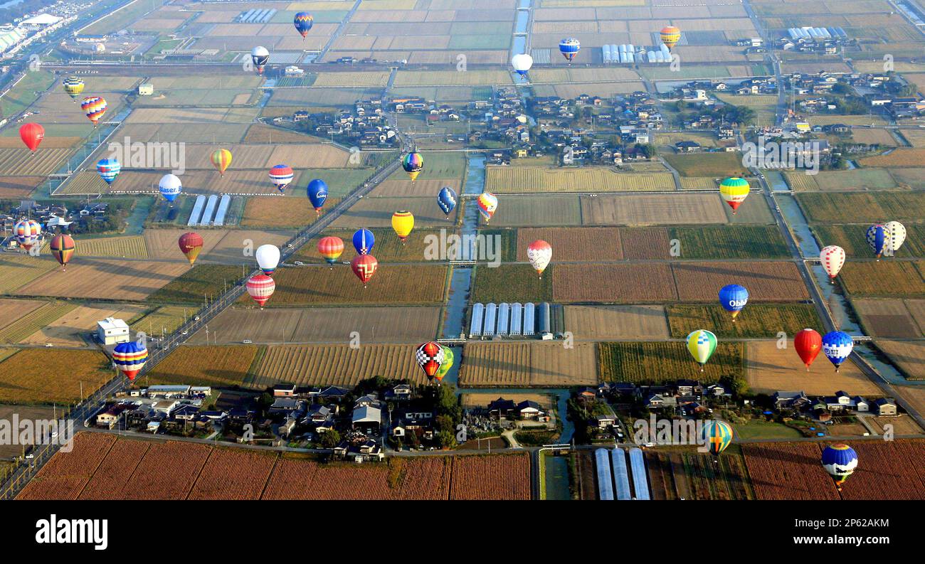 Colorful hot air balloons are floating up in the morning sky at the Saga International Balloon ...