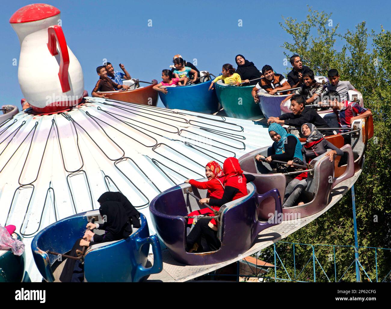 Iraqis enjoy a ride at Amusement City fairgrounds during Eid al-Adha ...