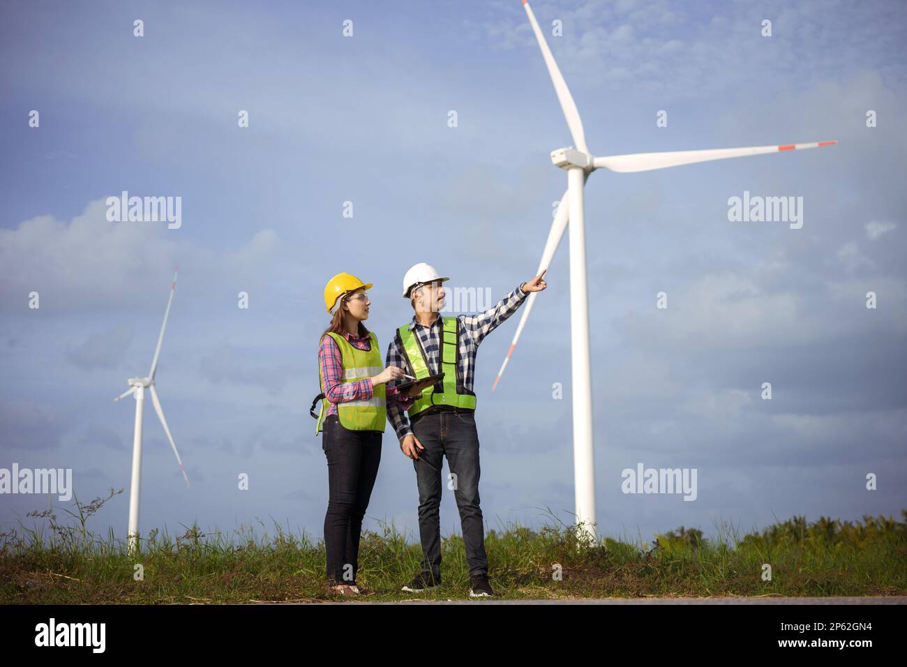 Team of asian engineers discussing and progress check wind turbine ...