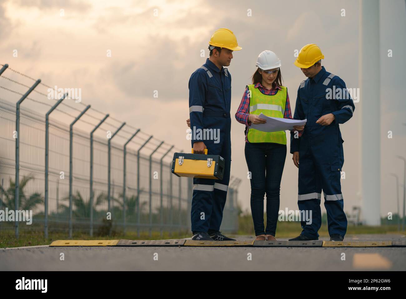 Three technician engineer in uniform with standing and checking wind ...