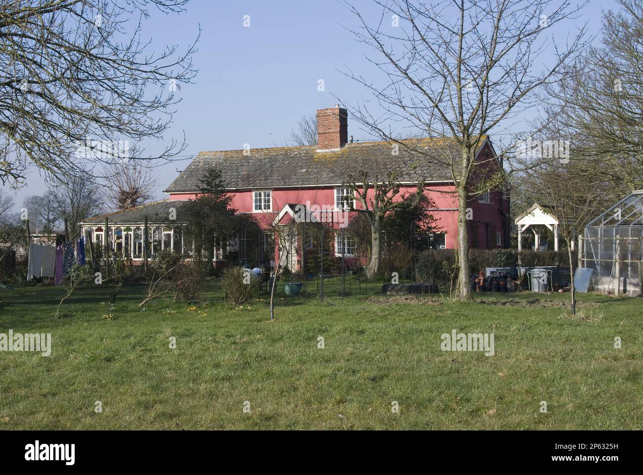 dusky pink farm house in winter garden Stock Photo - Alamy