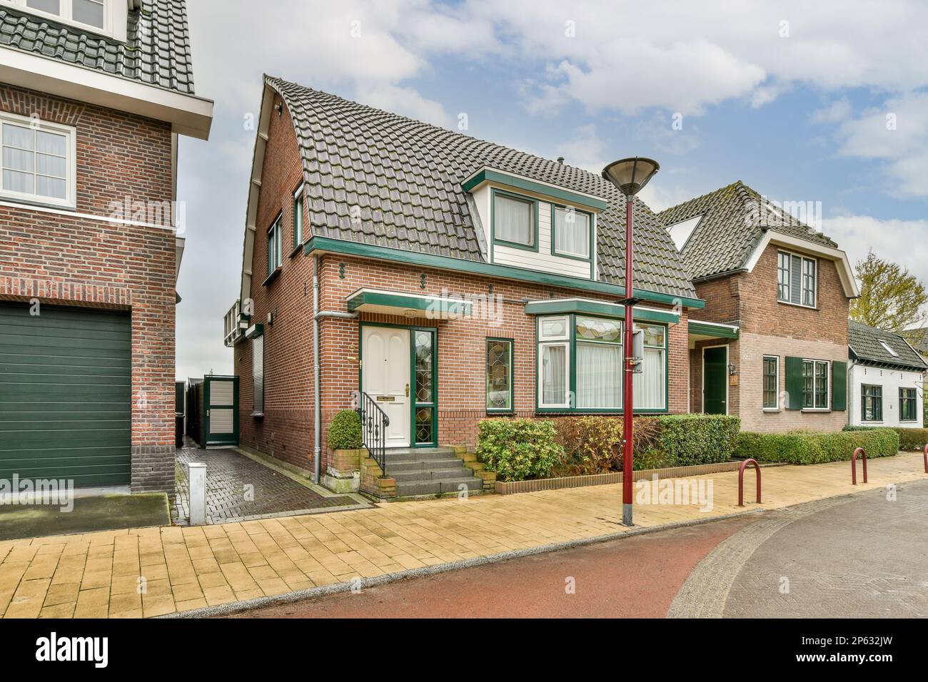 a street with houses and garages in the middle part of an area that ...