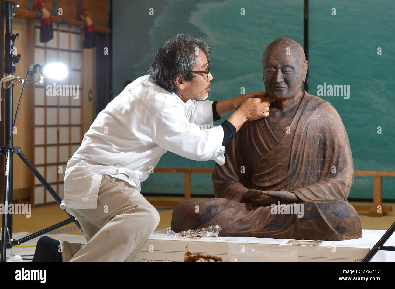 An artist studies a replica of a statue of Ganjin Wajo at Toshodaiji ...