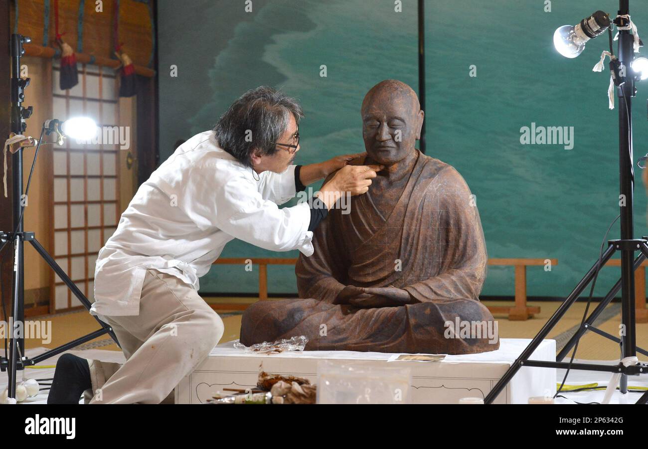 An artist studies a replica of a statue of Ganjin Wajo at Toshodaiji ...
