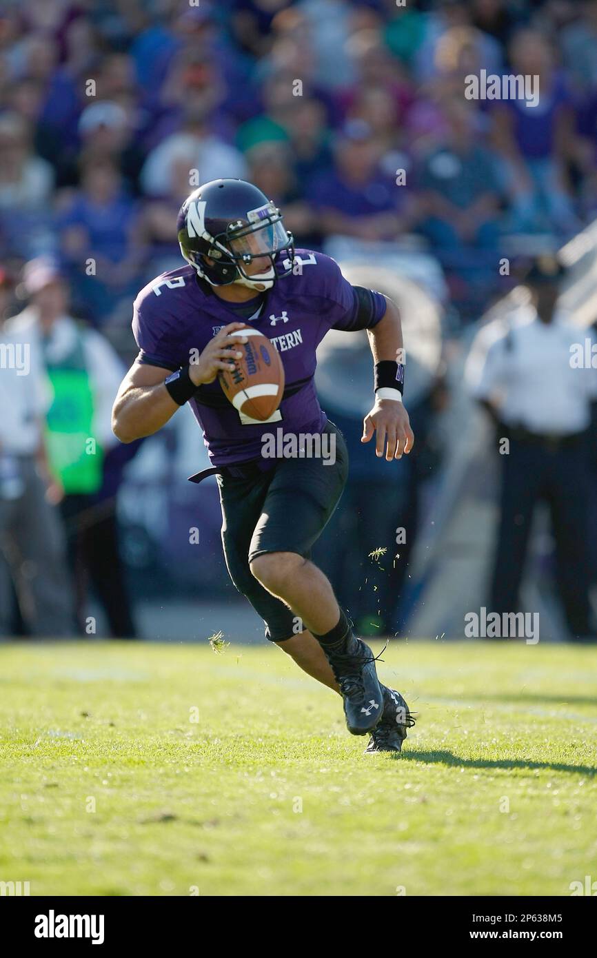 Northwestern quarterback Kain Colter (2) runs with the football in a ...