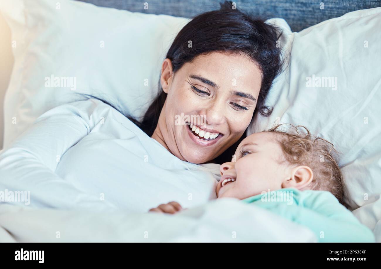 Love, baby and mother relax in bed, waking up and bonding, happy and ...