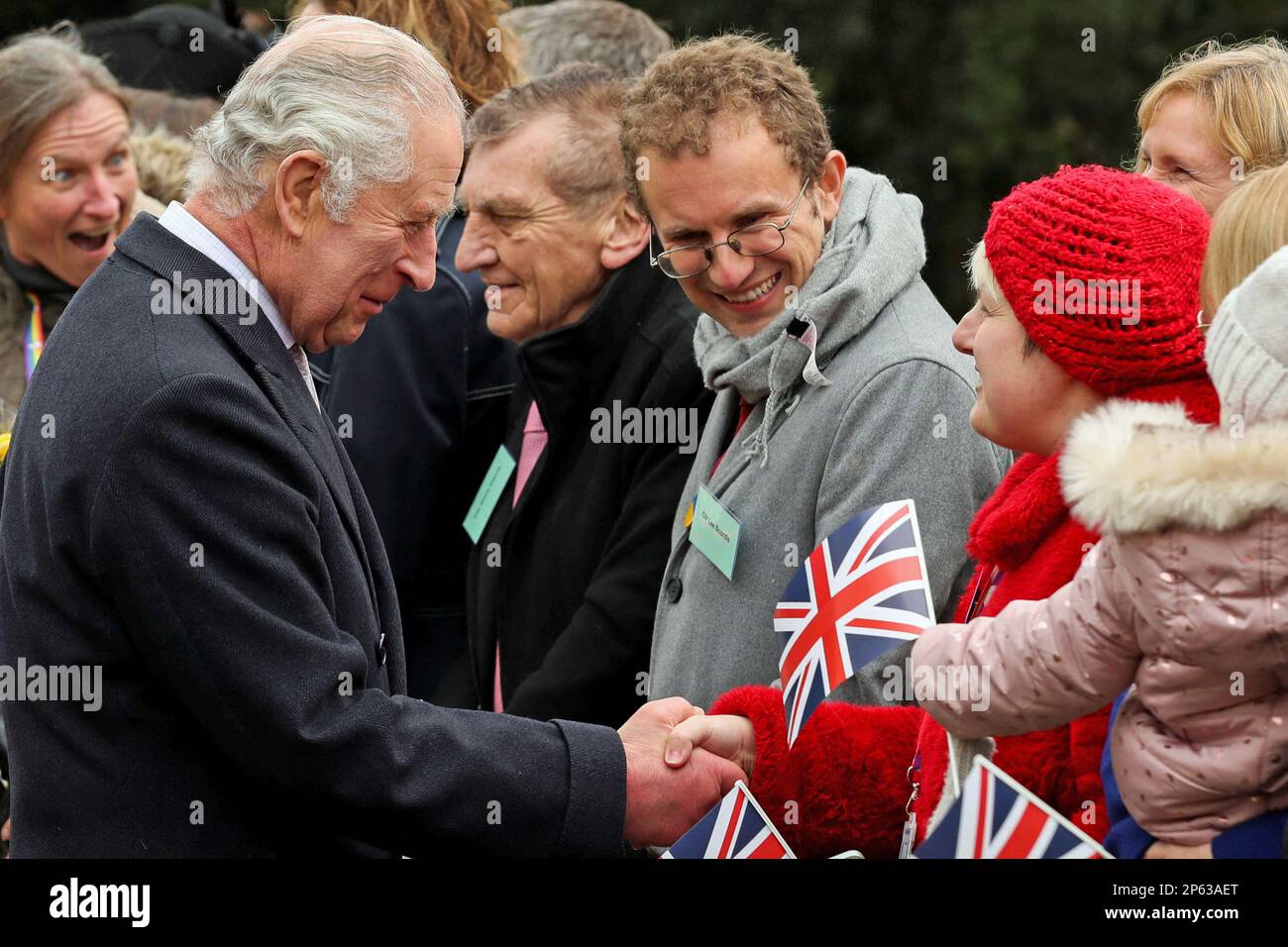 King Charles III shakes hands with a member of the public as he arrives ...
