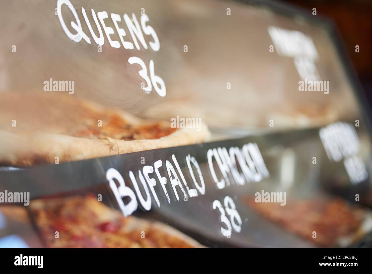 Shop display, pizza and fast food price, service and take away restaurant with closeup ...