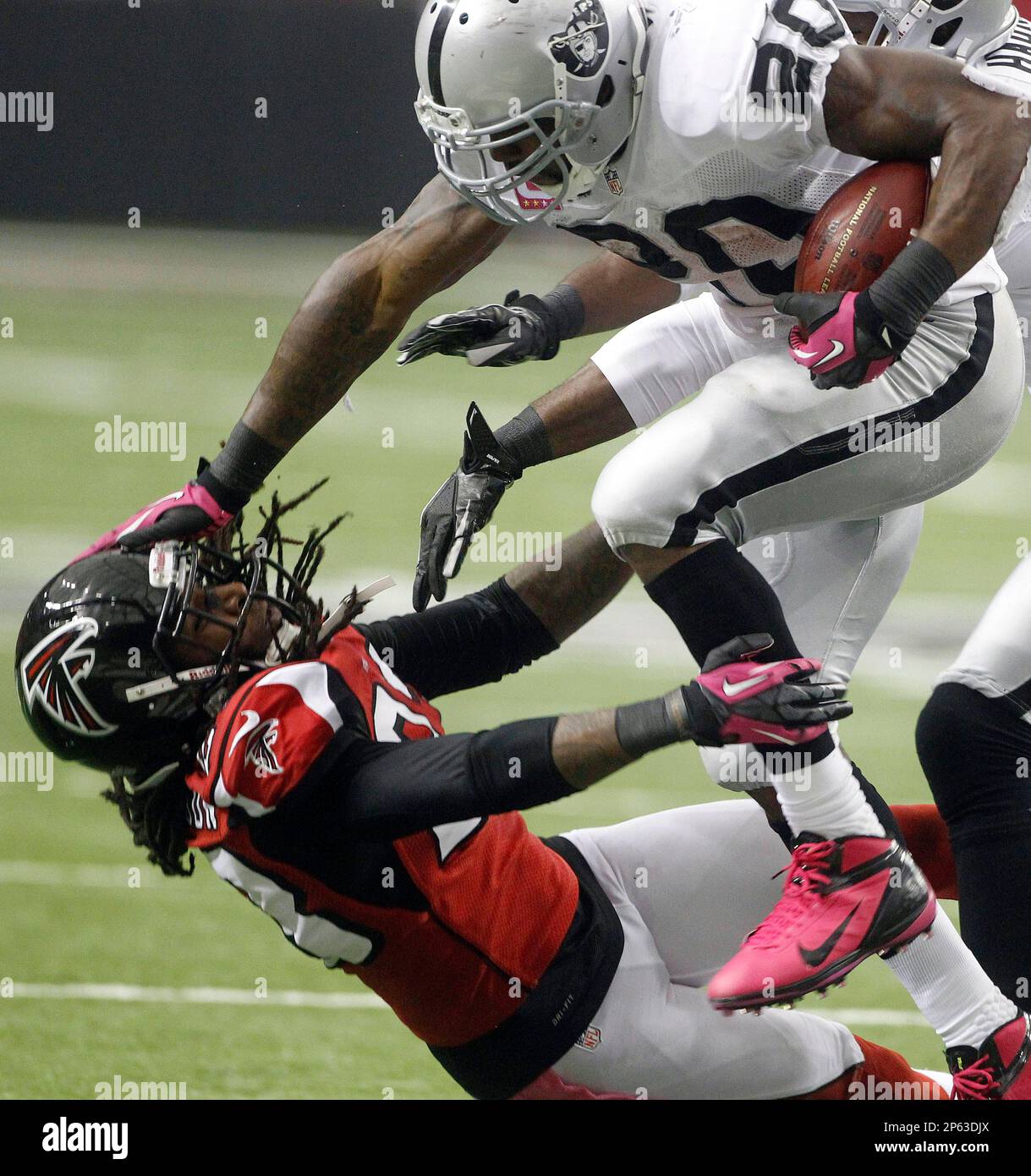 Oakland Raiders Darren McFadden (20) stiff-arms Atlanta Falcons ...