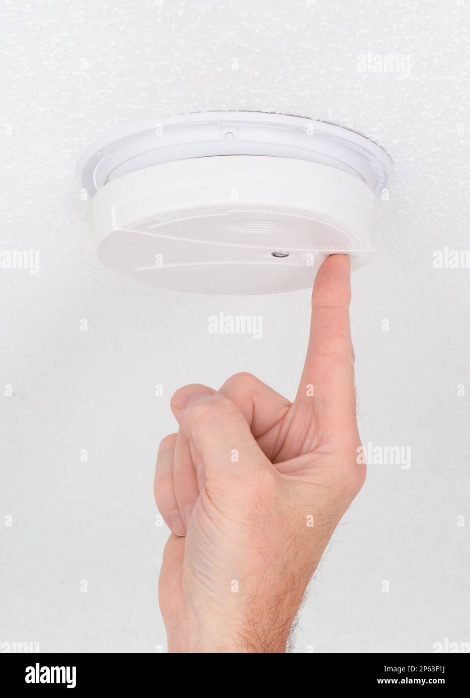 Man testing a smoke detector alarm Stock Photo - Alamy