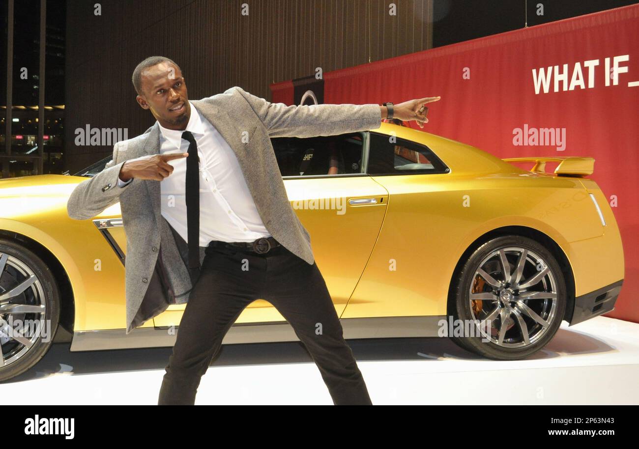 Jamaican star sprinter Usain Bolt poses in front of Nissan Motor Co's ...