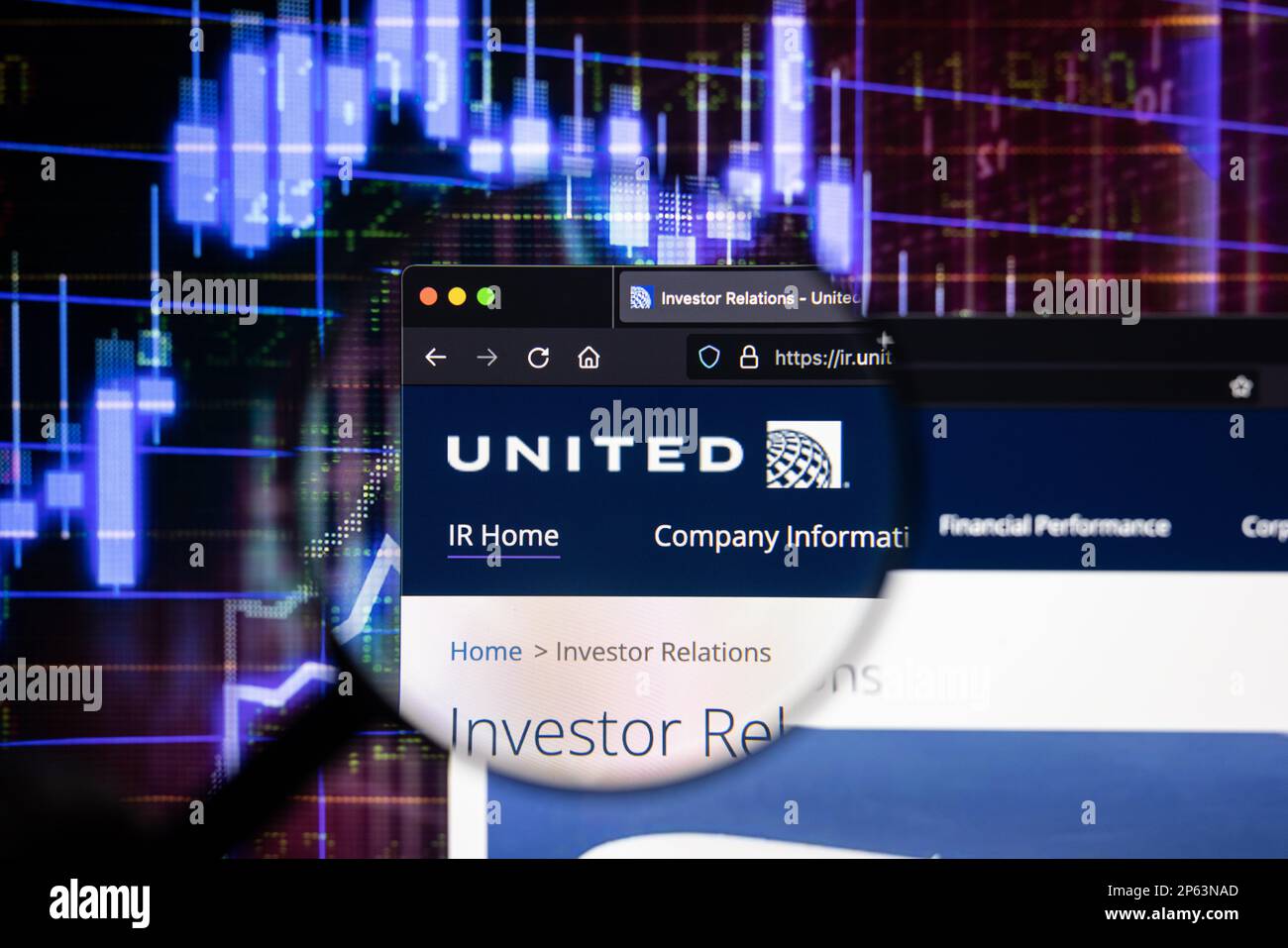 United Airlines company logo on a website with blurry stock market developments in the ...