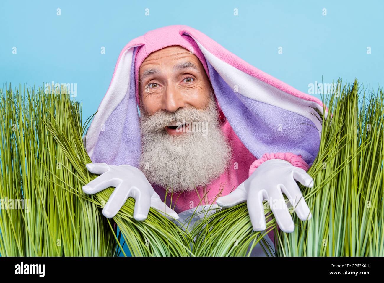 Photo of excited positive retired man wear pink hare pajama playing ...