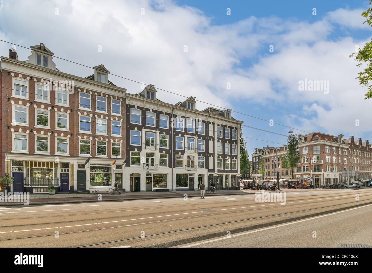 a city street with buildings on both sides and cars parked along the ...