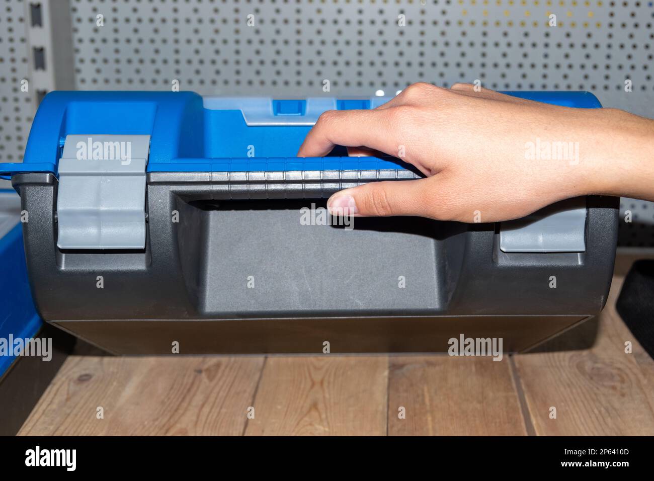 The hand of a working man pulling a construction tool kit from the ...