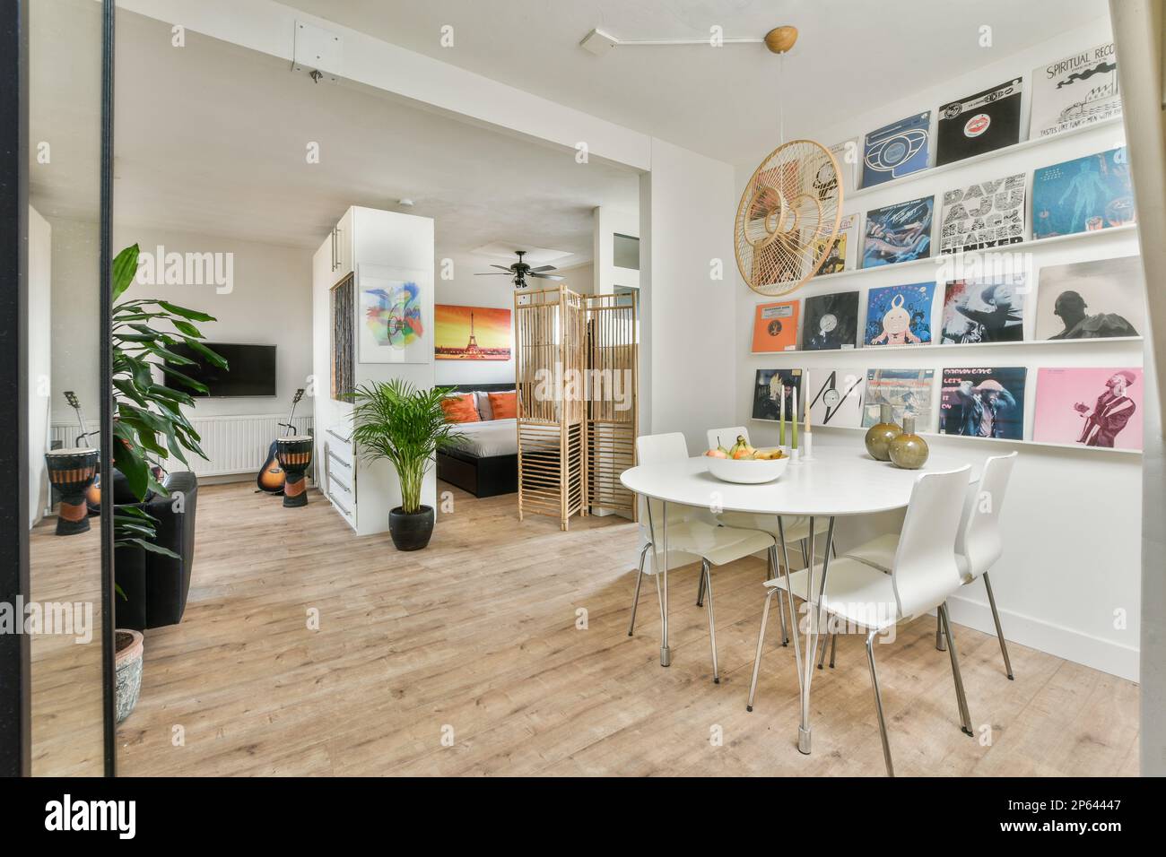 a living room with white furniture and pictures on the wall above it ...