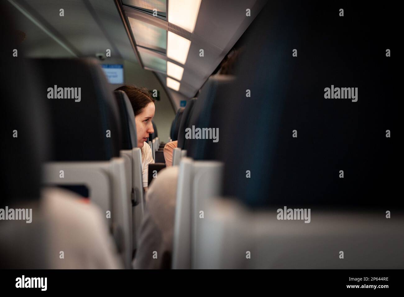 Picture of a woman discussing on typical seat from a European train, en ...