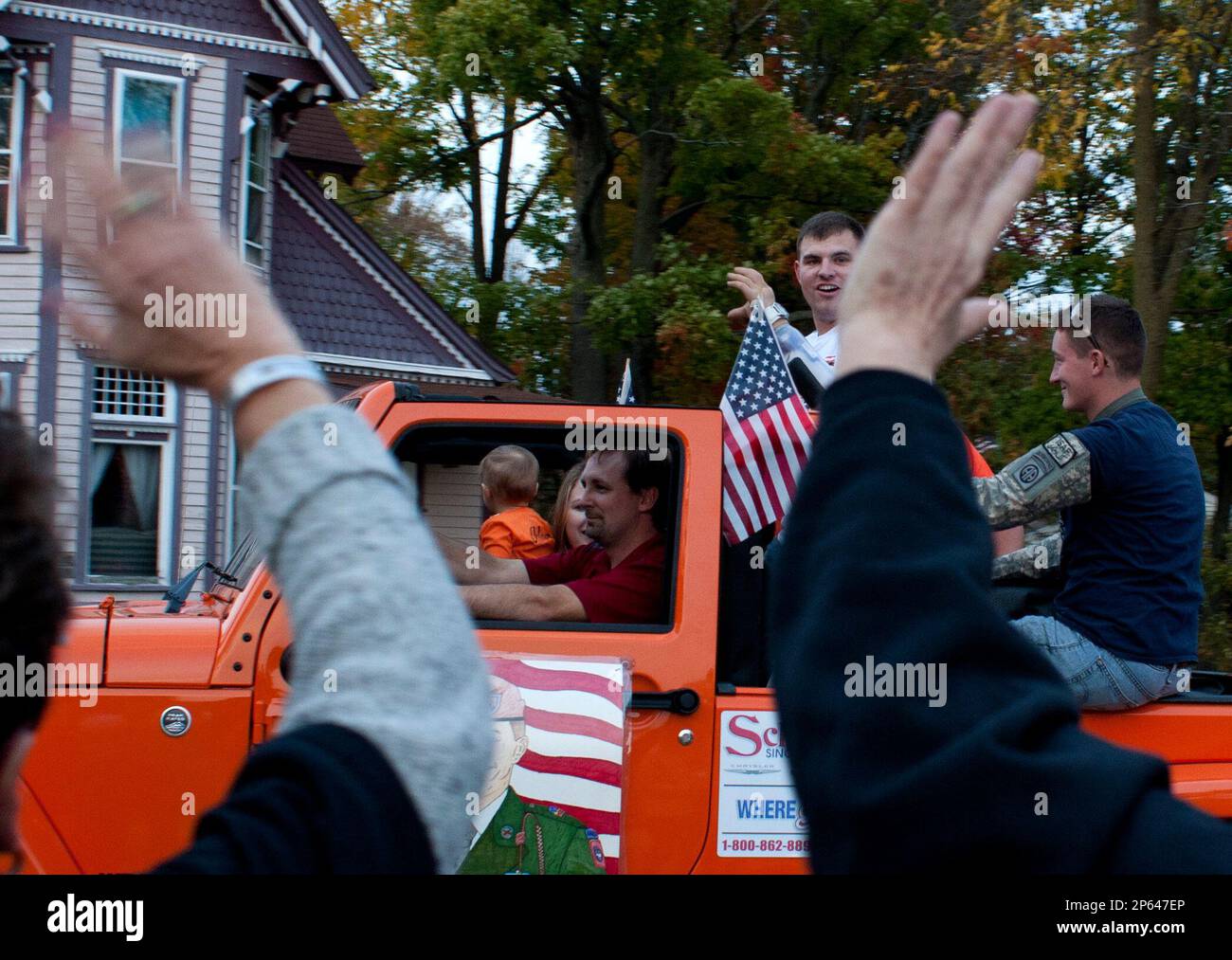 Army Staff Sgt. Travis Mills waves during a parade to welcome him back ...