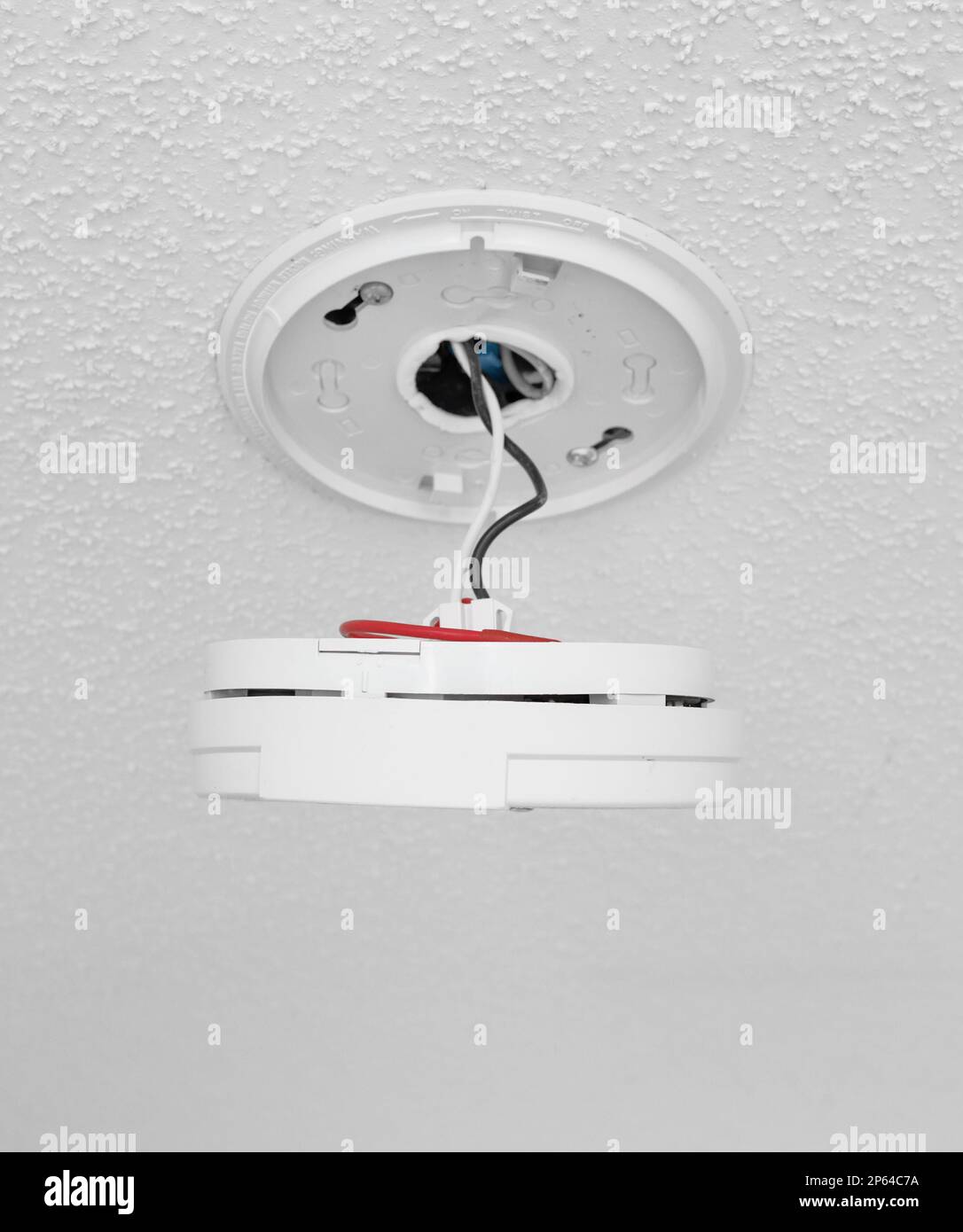 Checking wired in ceiling smoke detector Stock Photo - Alamy