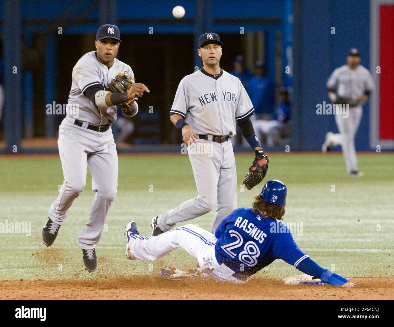 New York Yankees Robinson Cano, left, throws to first as Toronto Blue ...