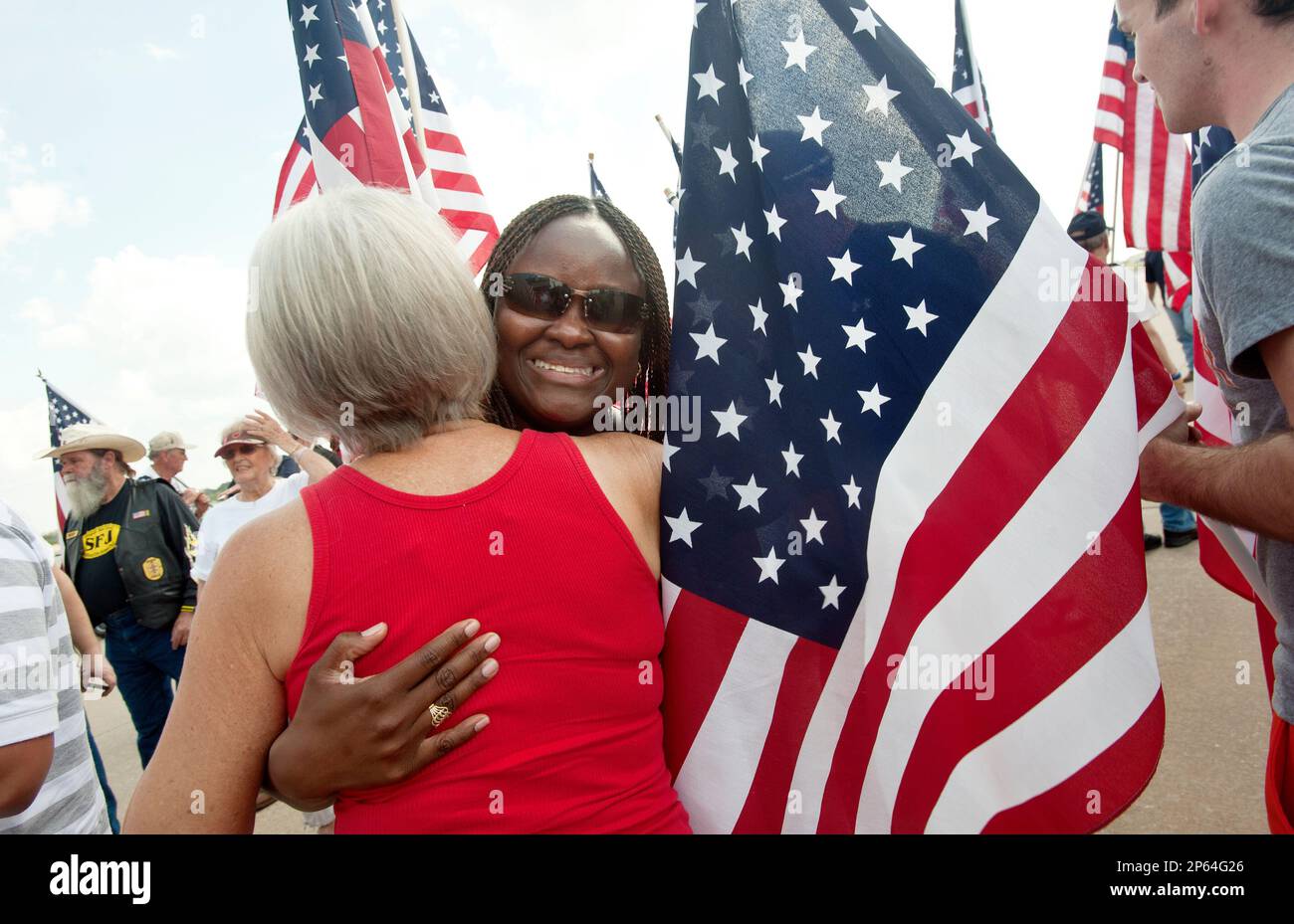 United States Army Captain Marie Marin of San Antonio is hugged by a ...